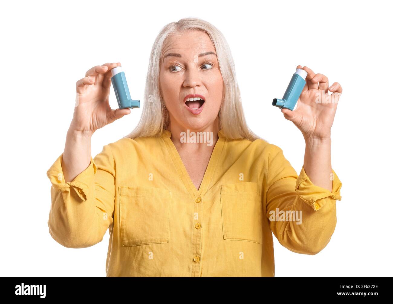 Mature woman with inhalers on white background Stock Photo - Alamy