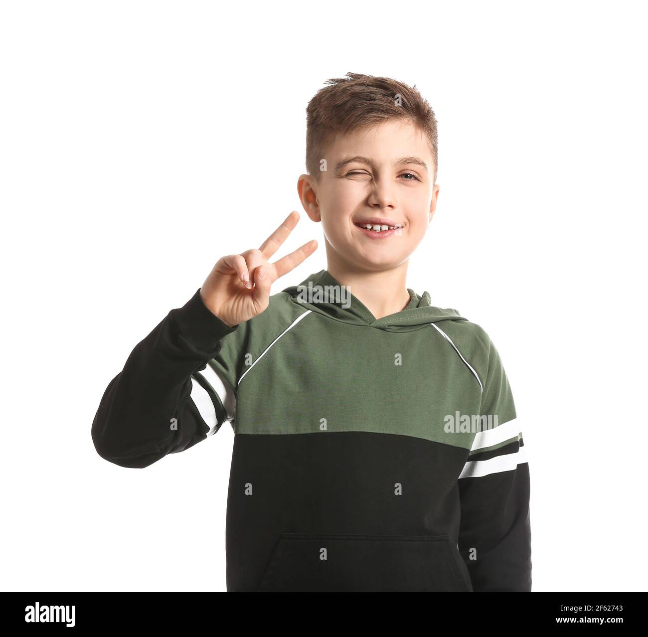 Happy little boy showing victory gesture on white background Stock ...