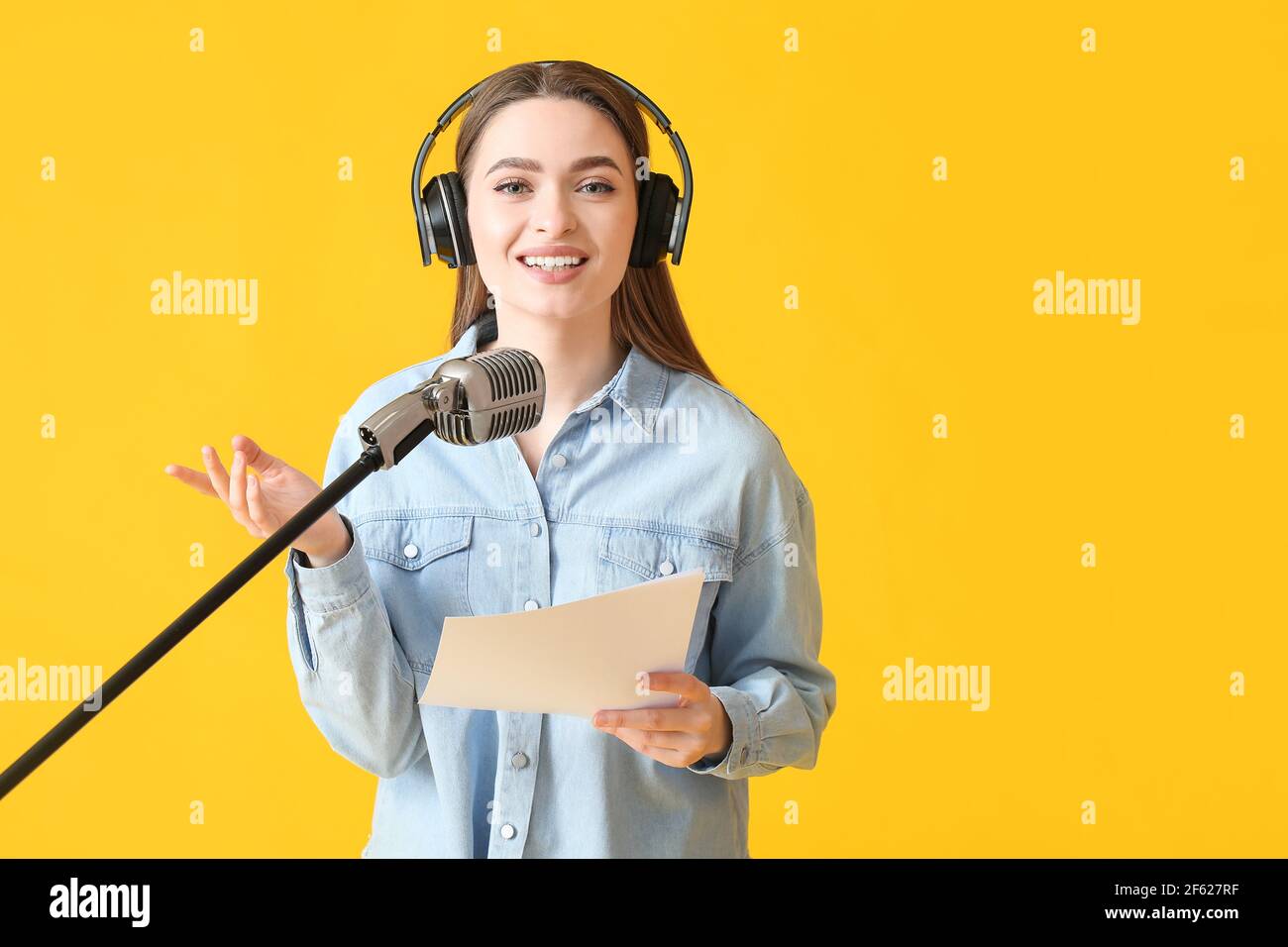 Female radio presenter with microphone on color background Stock Photo ...
