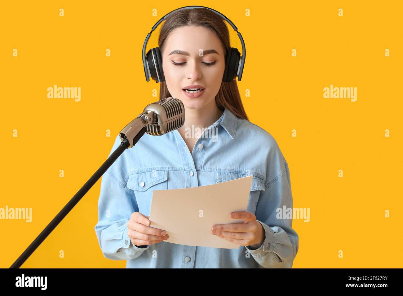Female radio presenter with microphone on color background Stock Photo ...