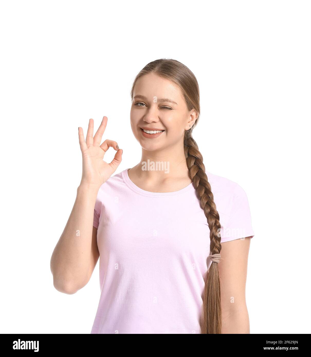 Beautiful smiling young woman showing OK on white background Stock ...