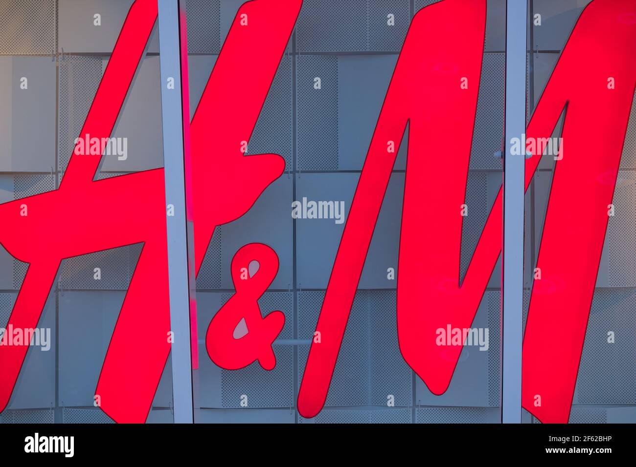 H&M shop sign, red on show windows background Stock Photo - Alamy
