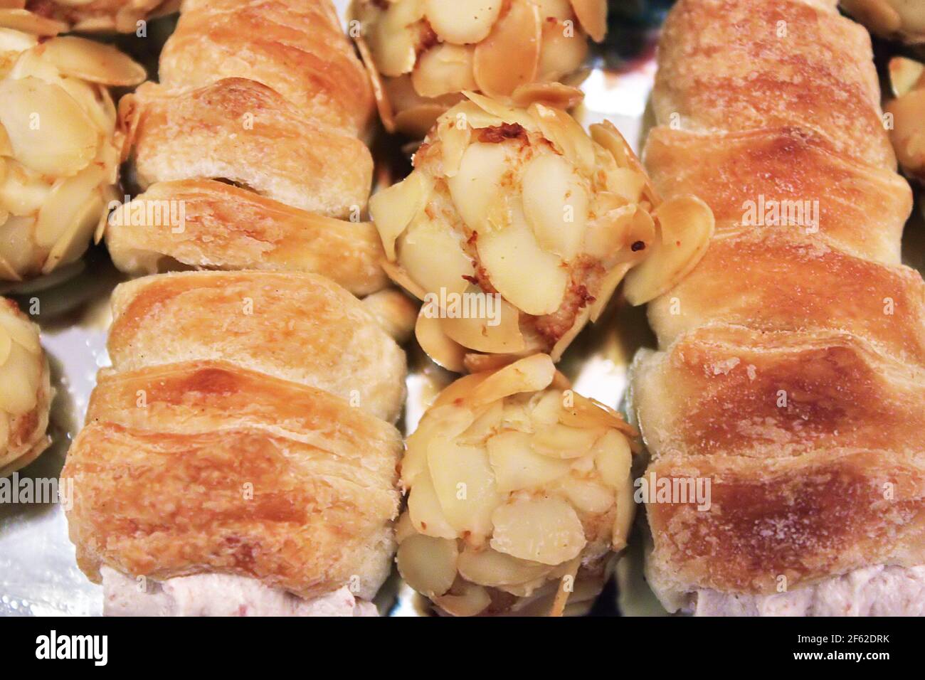 Puff pastry appetizers and balls topped with nuts Stock Photo - Alamy