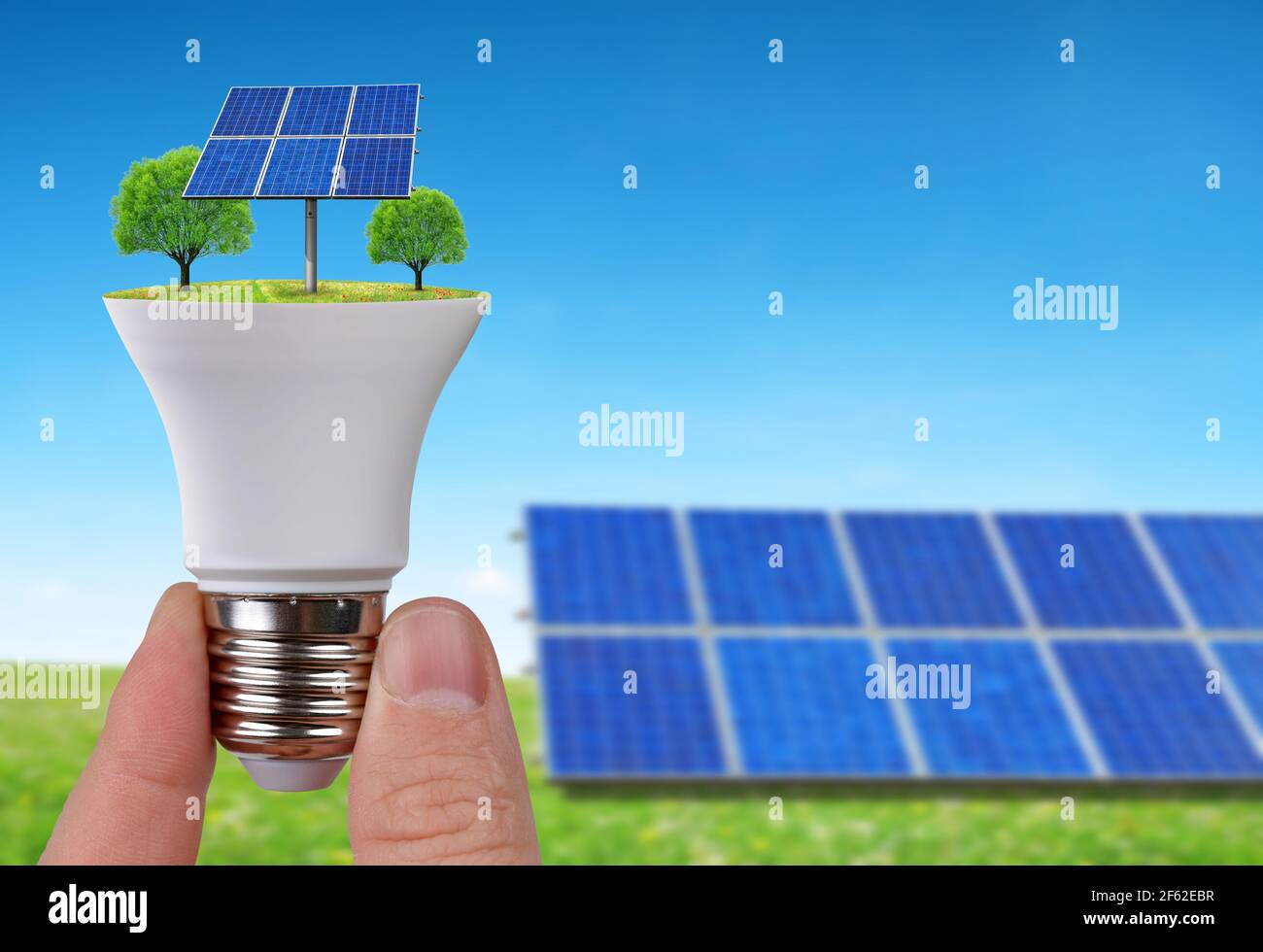 Eco LED light bulb with solar panels in hand. Concept of green energy ...