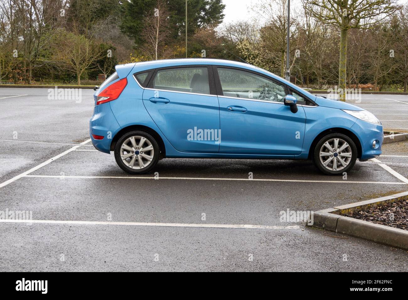 Hampshire, England, UK. 2021. Small blue saloon car on a parking lot on ...