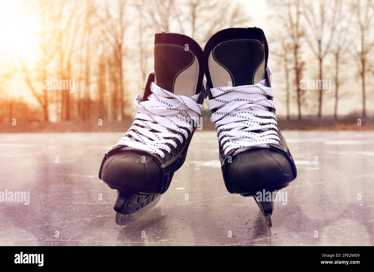 Black hockey skates on a ice rink Stock Photo - Alamy