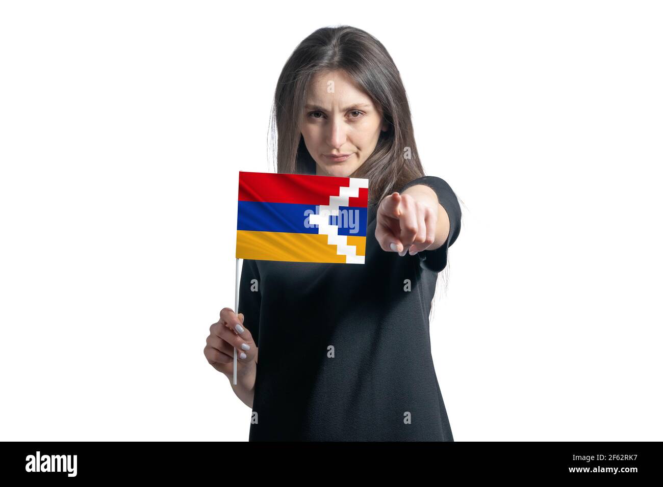 Happy young white woman holding flag of Nagorno-Karabakh Republic and points forward in front of ...