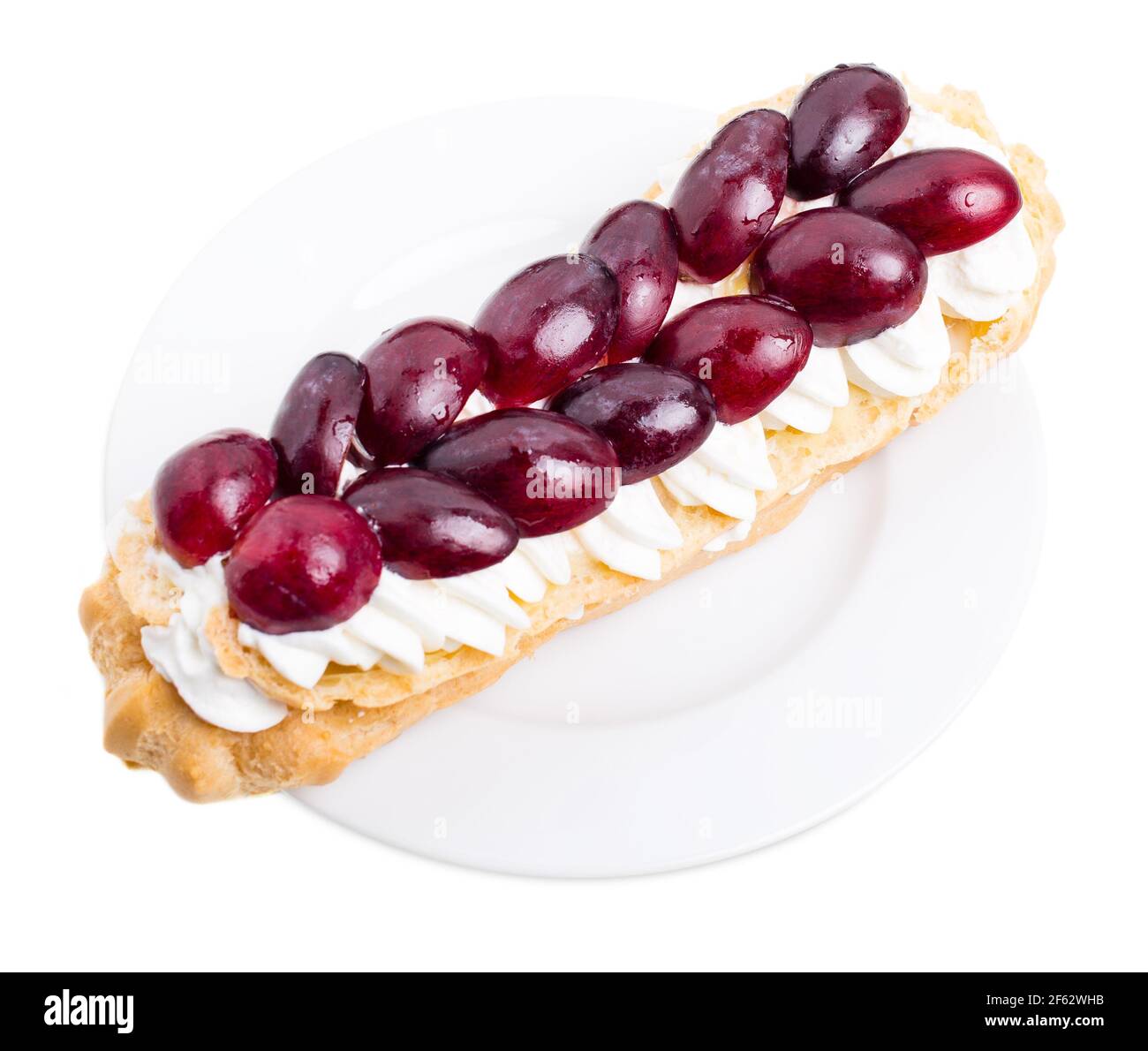 Classic eclair filled with custard and sliced red grapes. Isolated on a ...