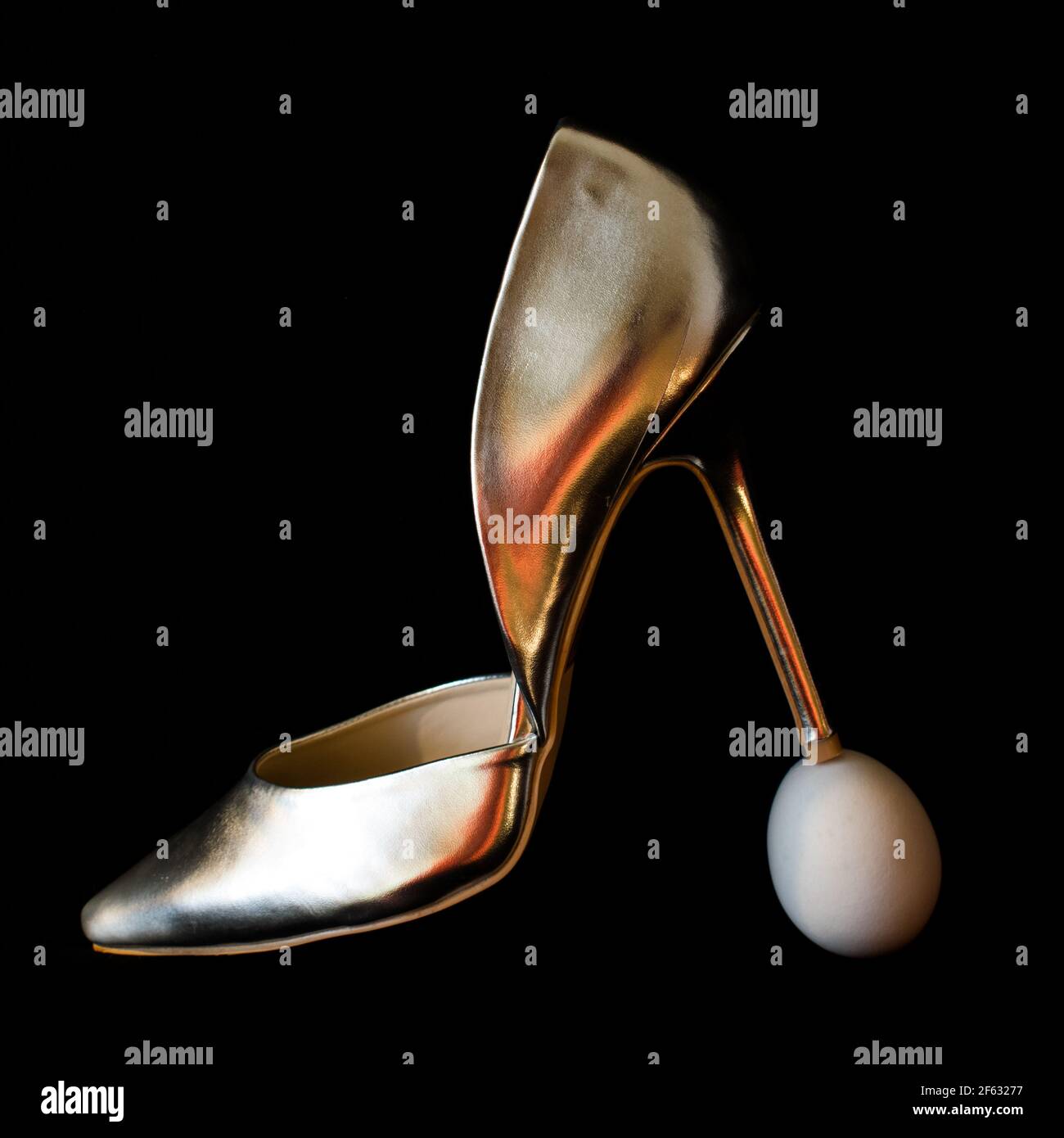 High heel shoe pressing an egg Stock Photo - Alamy