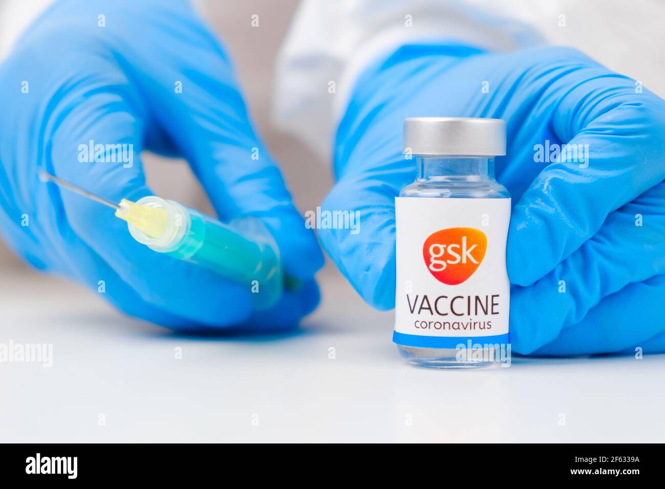 GSK vaccine against coronavirus and syringe for injection in health ...