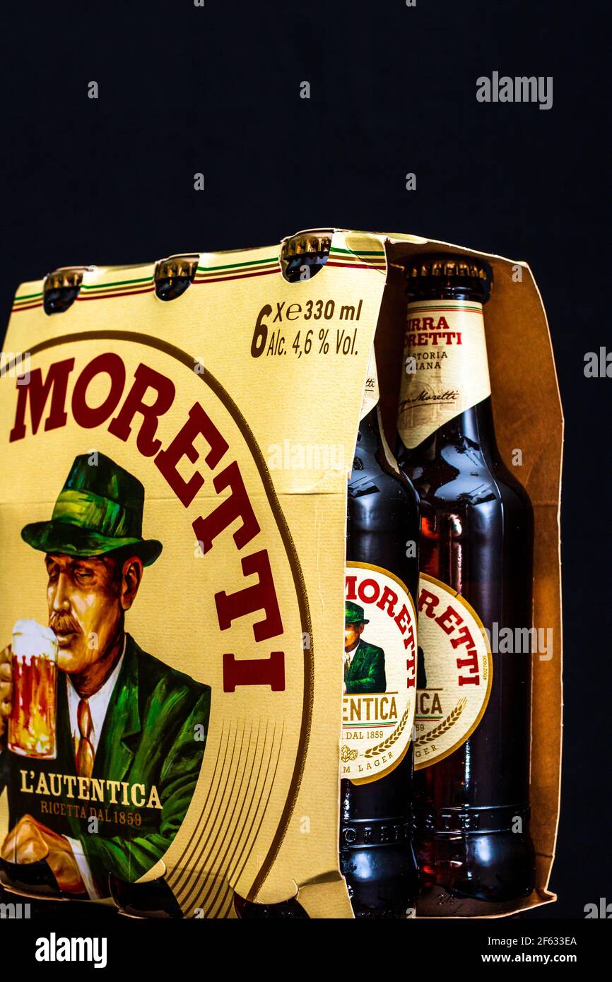 6 pack of Birra Moretti beer on wooden barrel with dark background ...