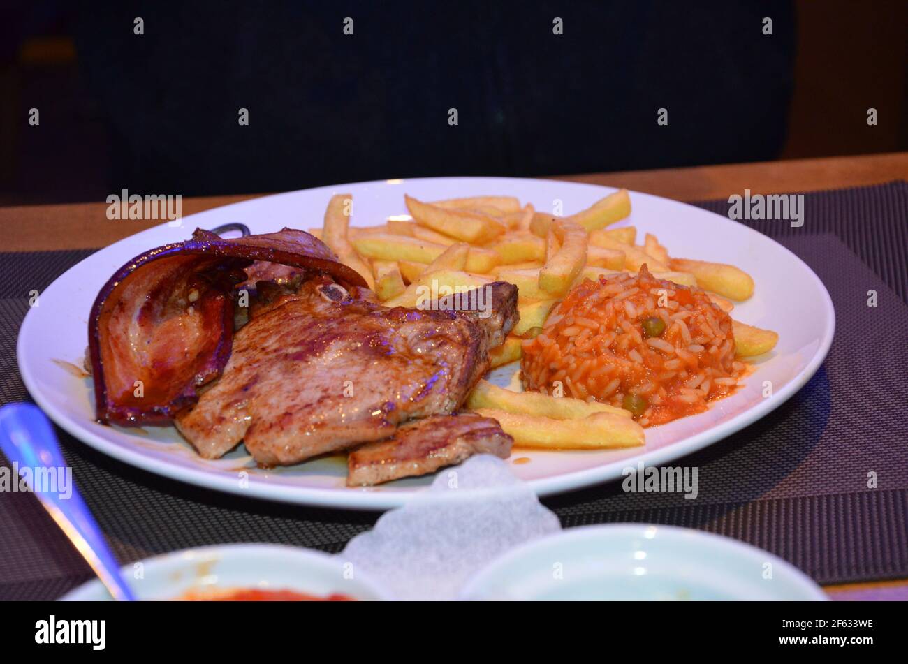 grilled meat, french fries, rice, lunch at a restaurant, grill plate ...