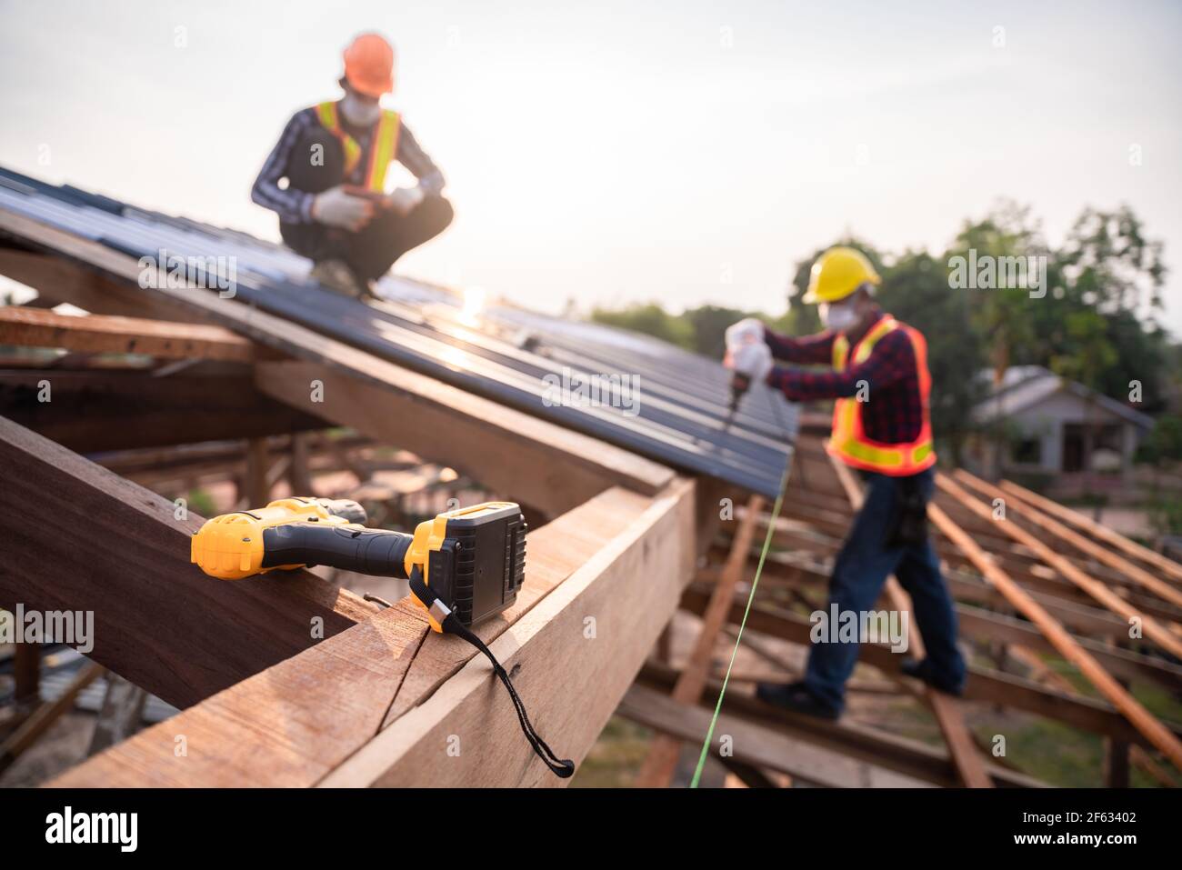 Selective focus Roofing tools, Roofer worker using a electric drill ...