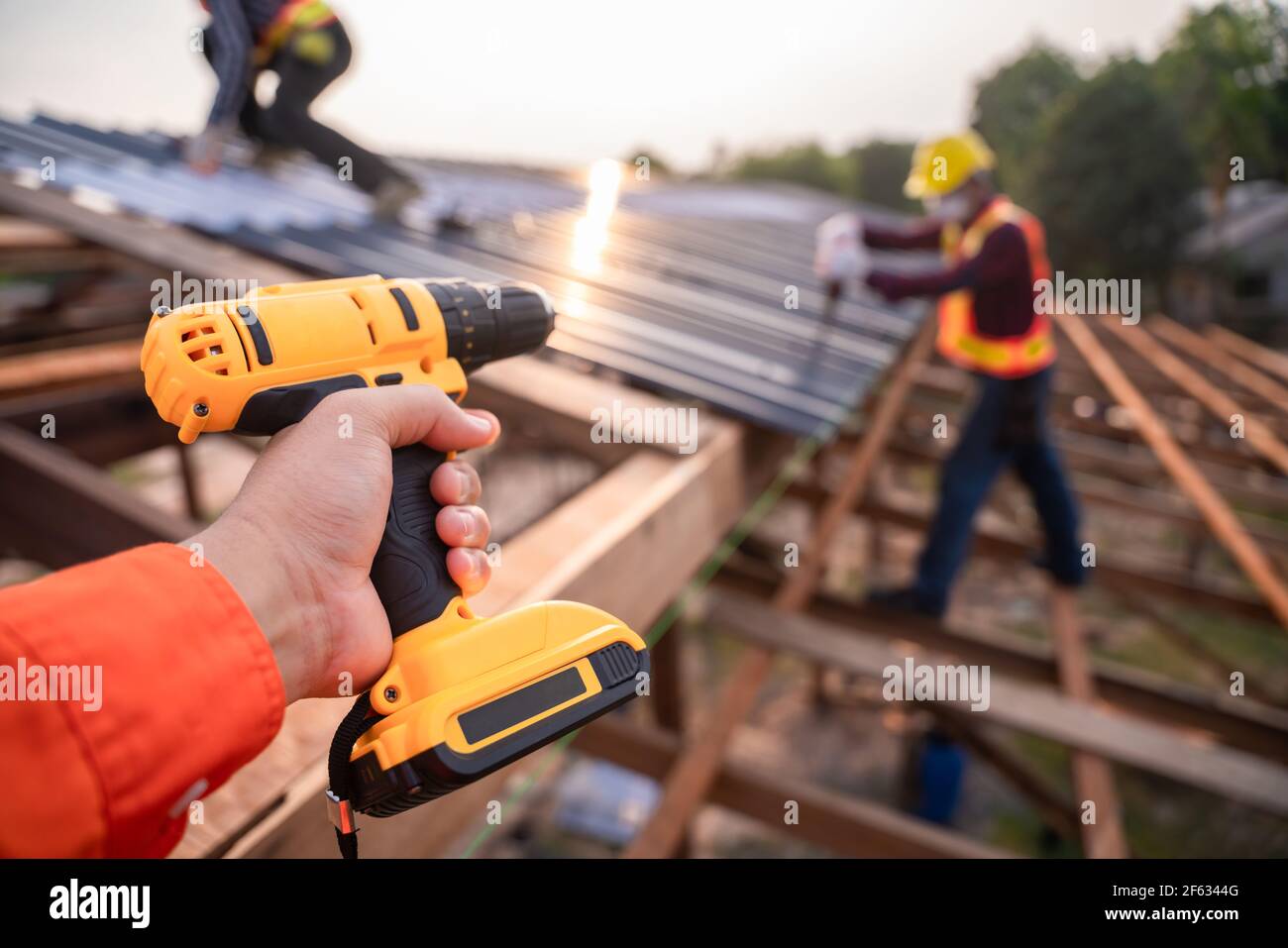 Selective focus Roofing tools, Roofer worker holding electric drill ...