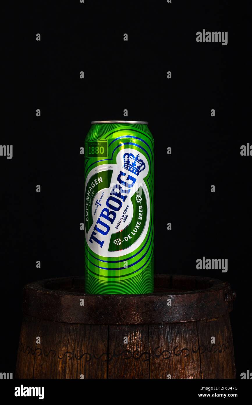 Can of Tuborg beer on beer barrel with dark background. Illustrative ...