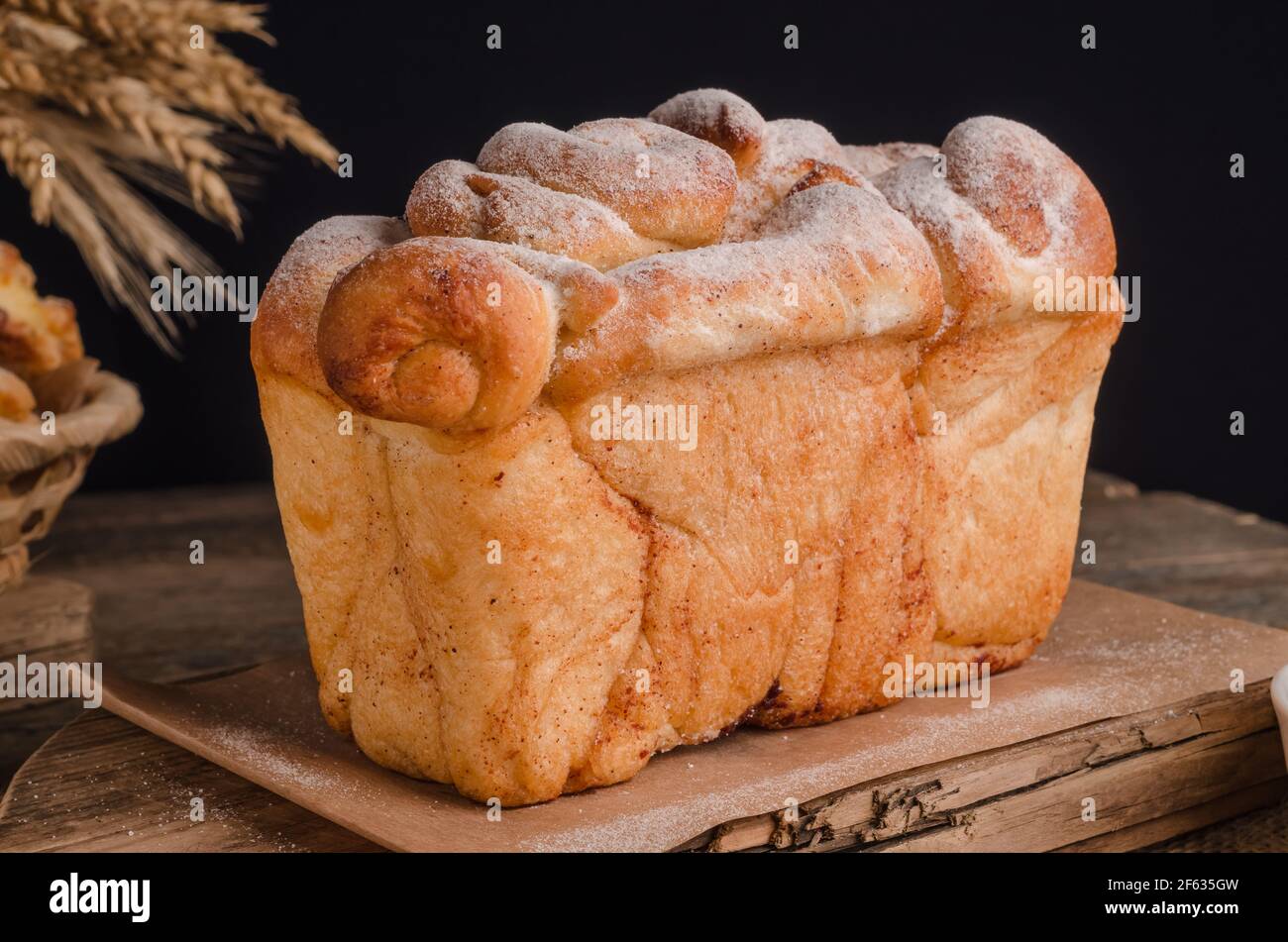 Beautiful loaf of white bread with curly top on wooden background Stock ...
