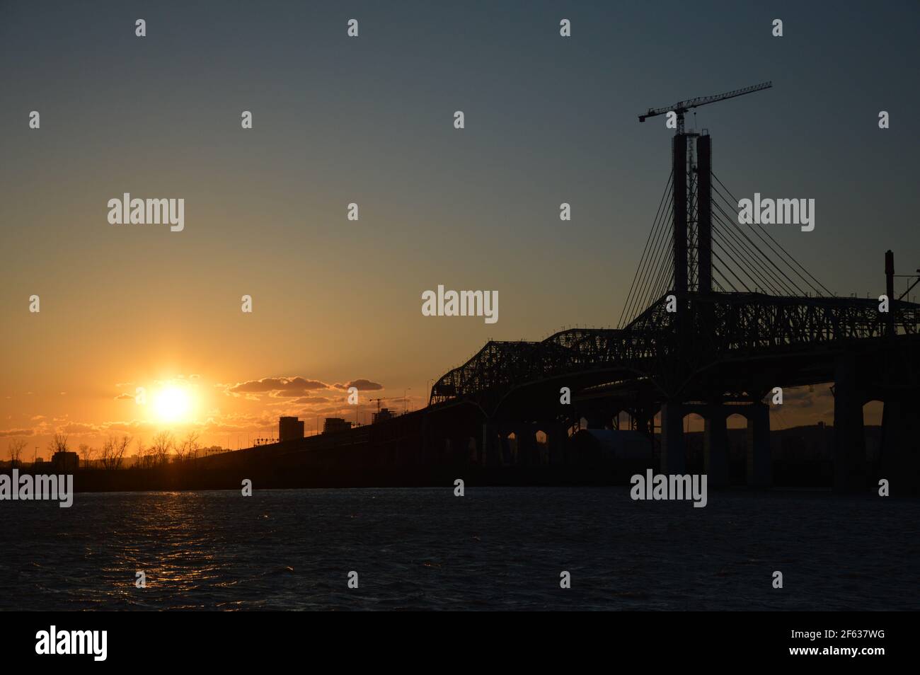 Waterfront sunset near bridge Stock Photo - Alamy