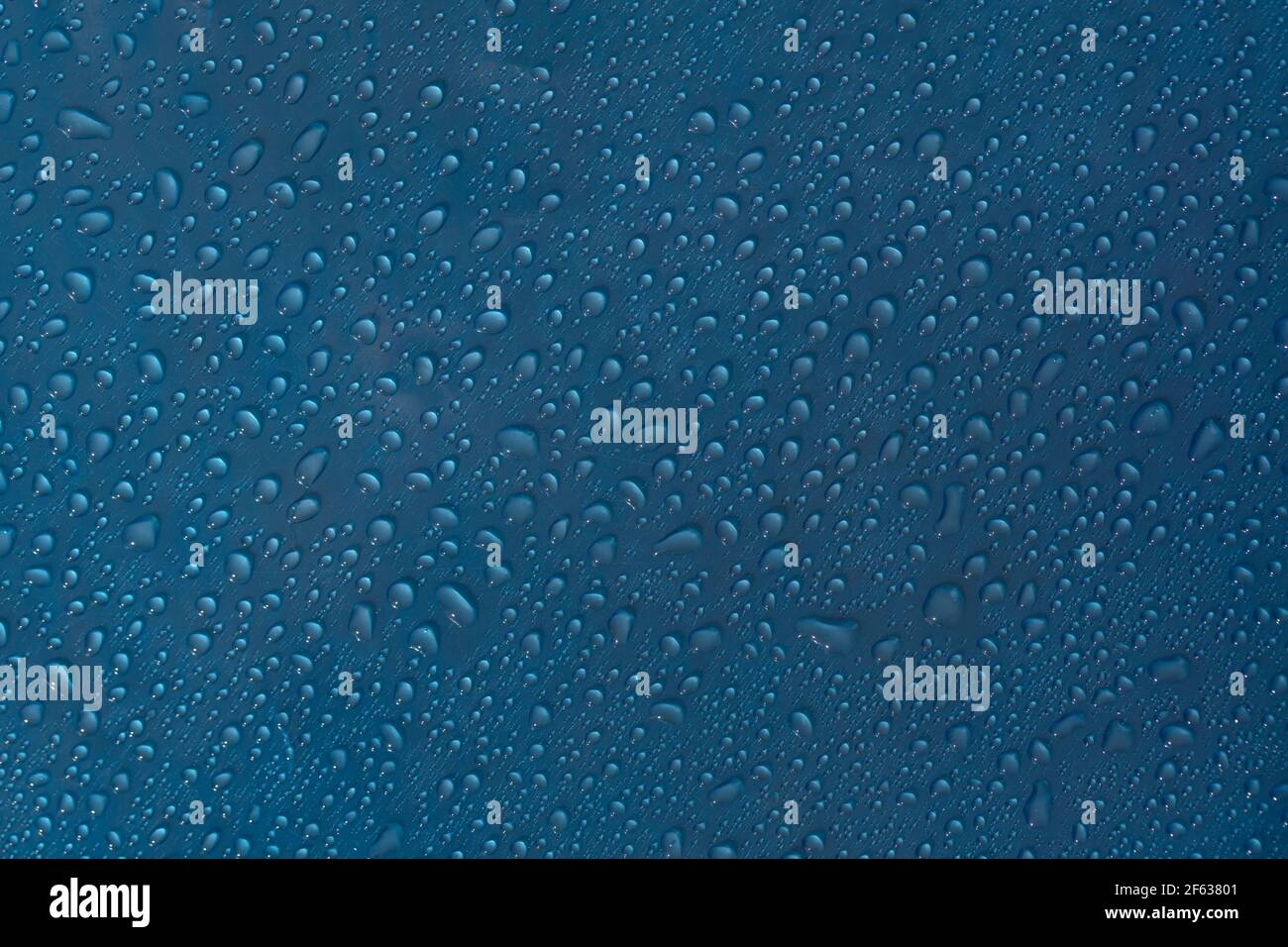 Droplet texture. Wet drop water on glass blue background Stock Photo ...