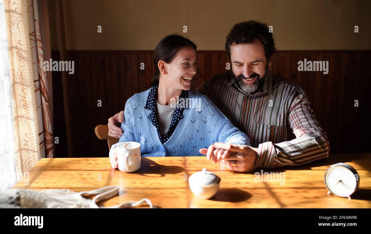 Portrait of happy poor mature couple resting indoors at home, poverty ...