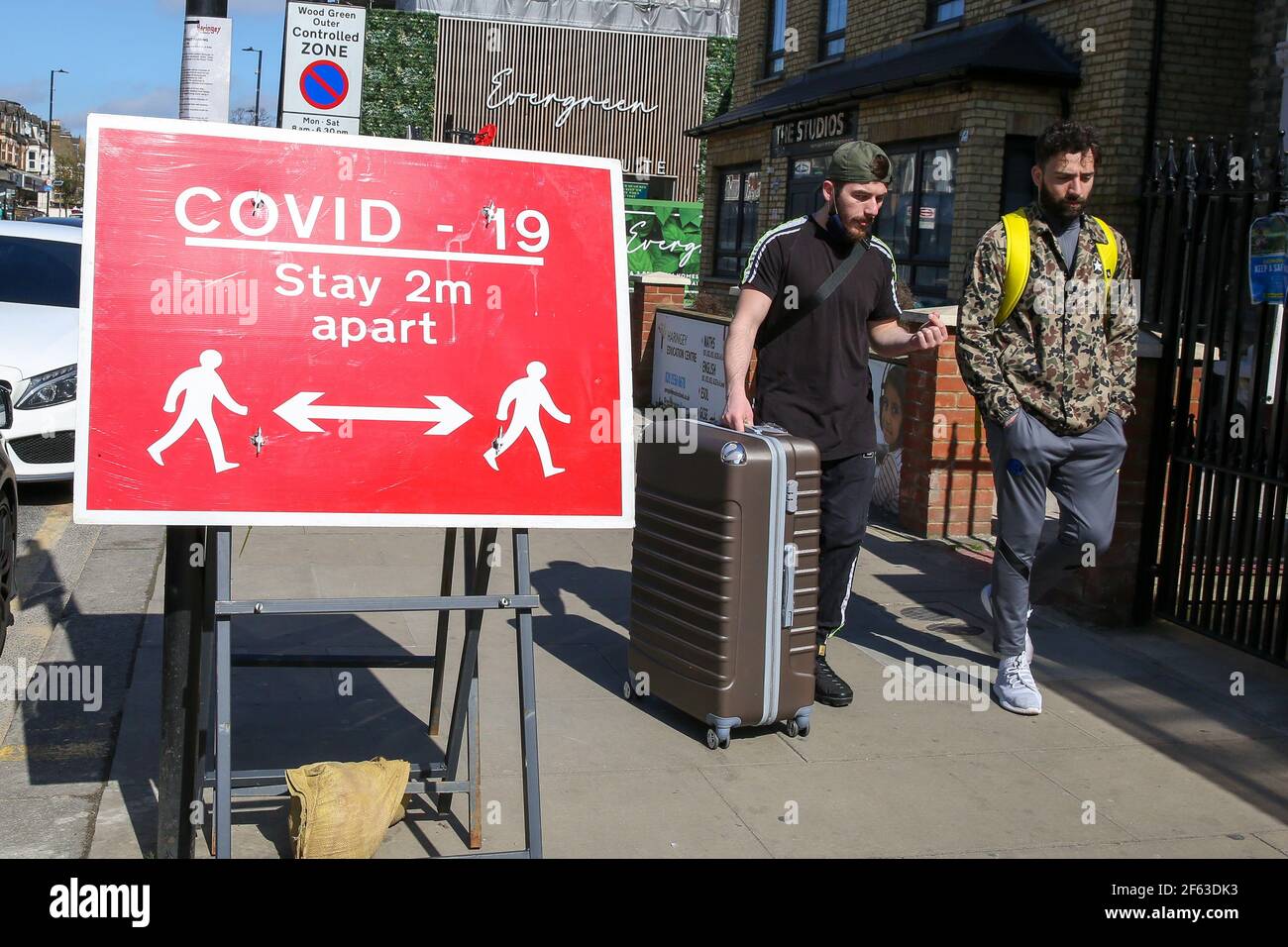 Men walk past signs hi-res stock photography and images - Alamy