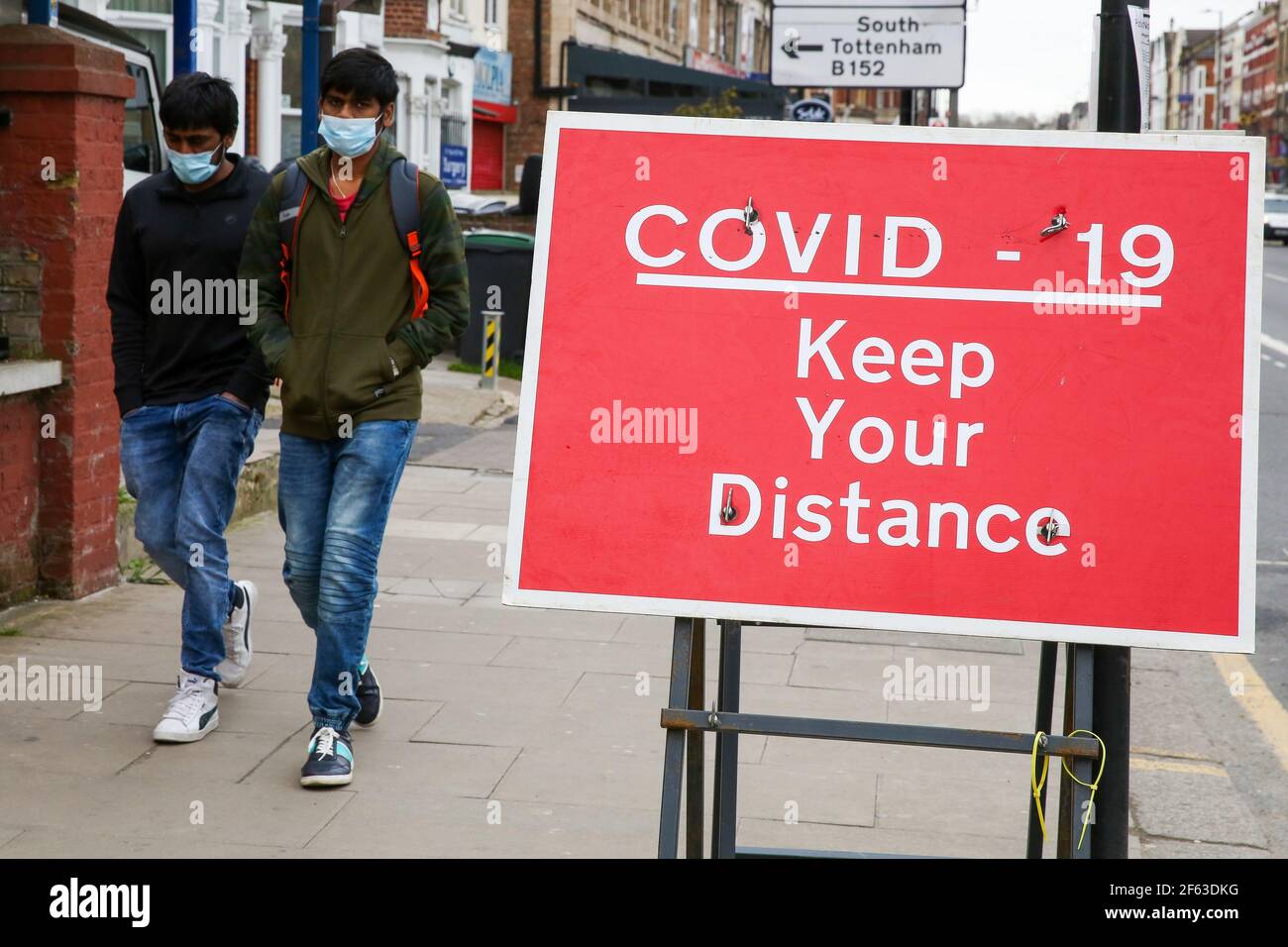 Men walk past signs hi-res stock photography and images - Alamy