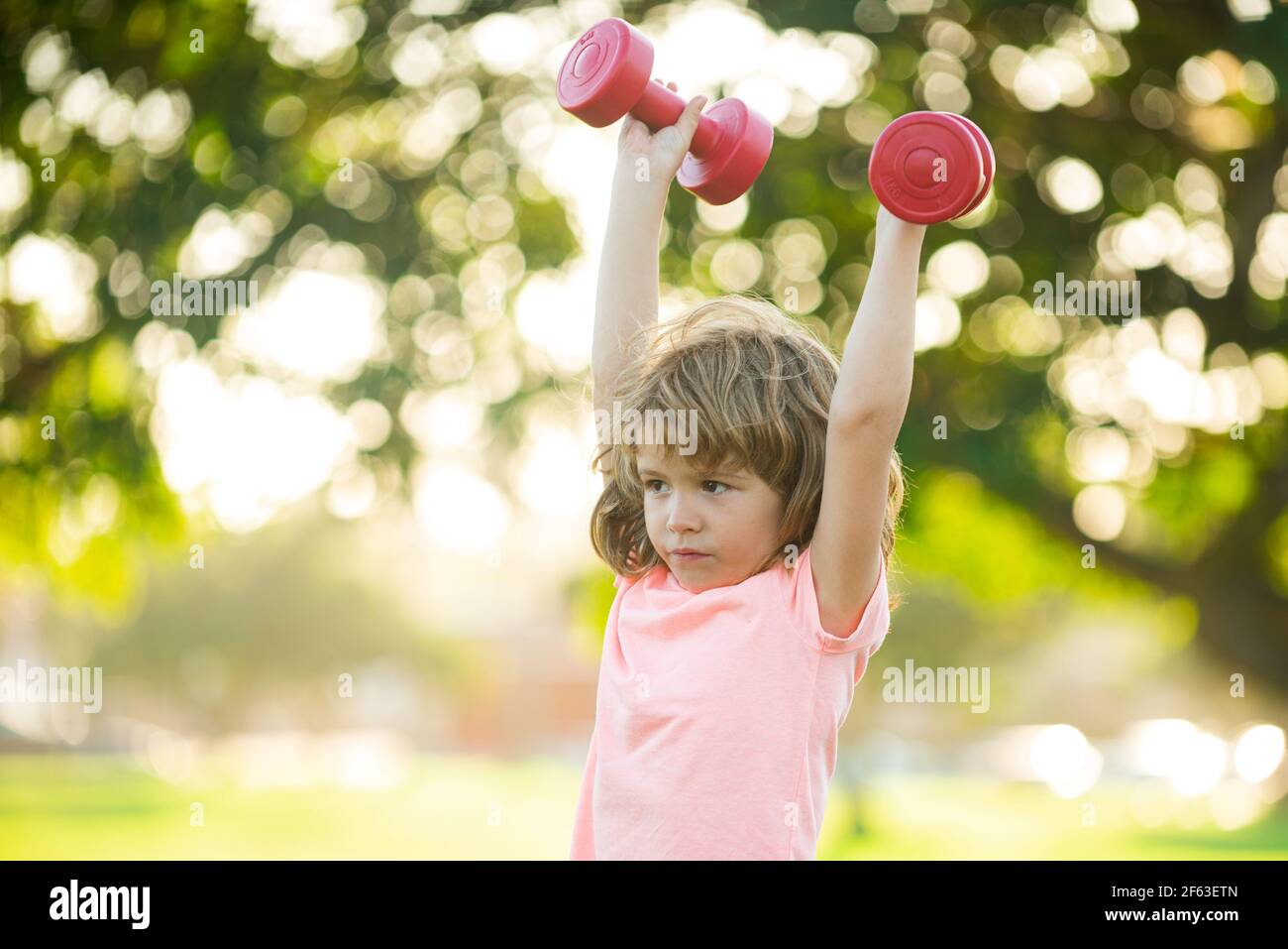 Kid boy exercising in park. Children healthy lifestyle. Sport child with strong muscles Stock ...
