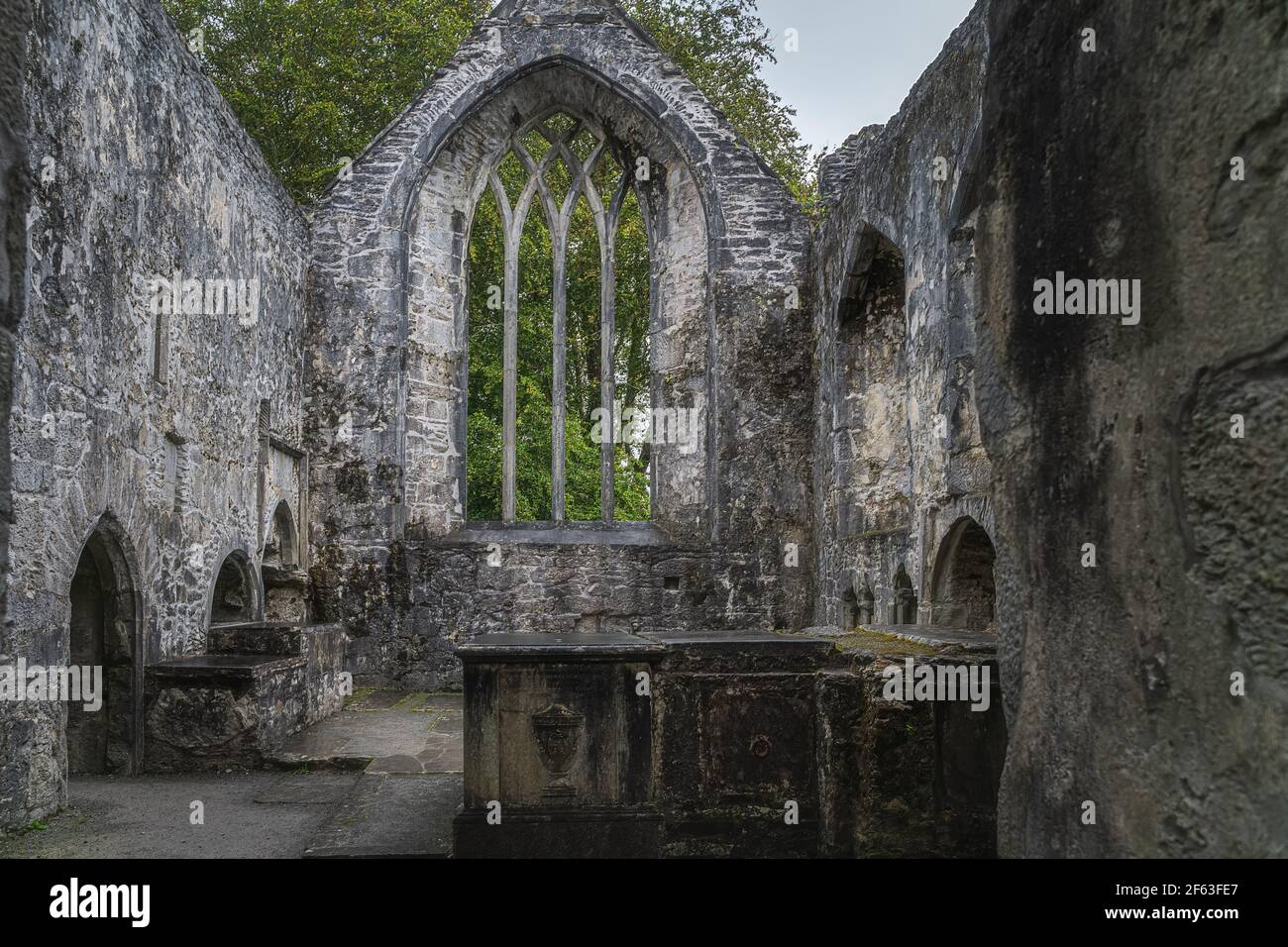 Window with arch, altars and tombs of ruined, 15th century monastery ...