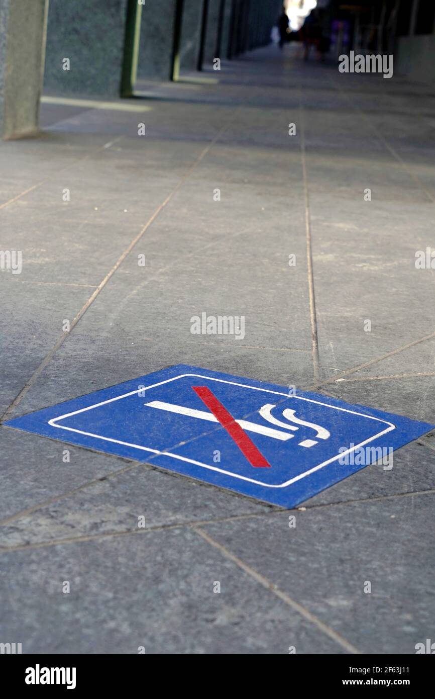 No smoking sign or smoking prohibited icon on the pavement of a street ...