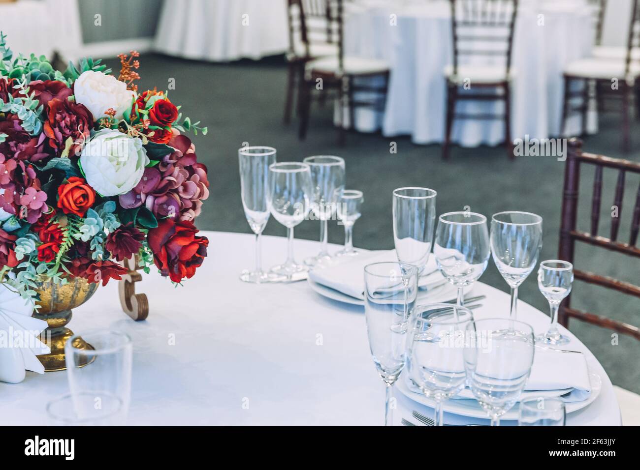 Fancy table set for dinner with flower composition in restaurant ...