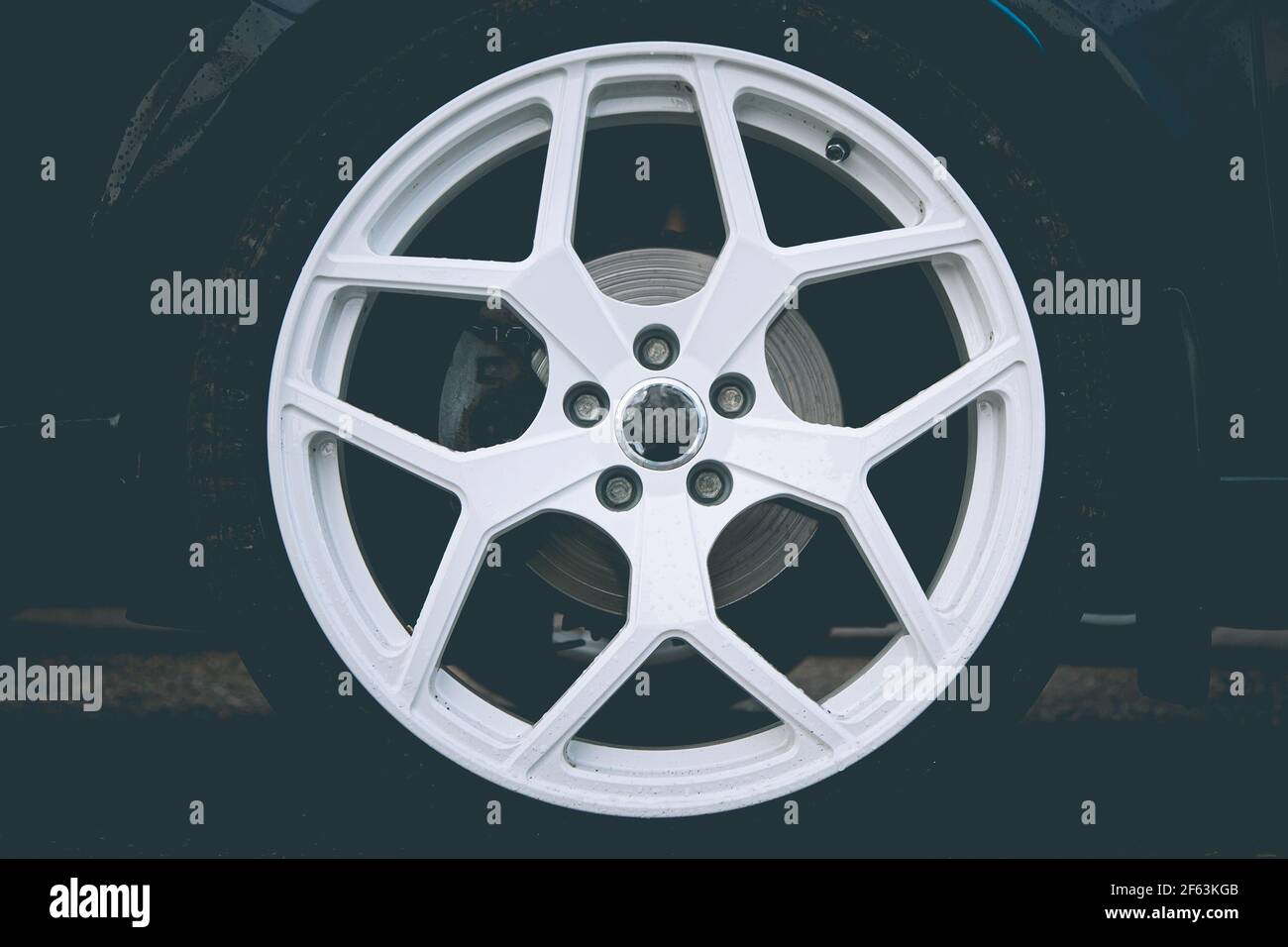 White alloy or forged wheels with tires on a car Stock Photo - Alamy