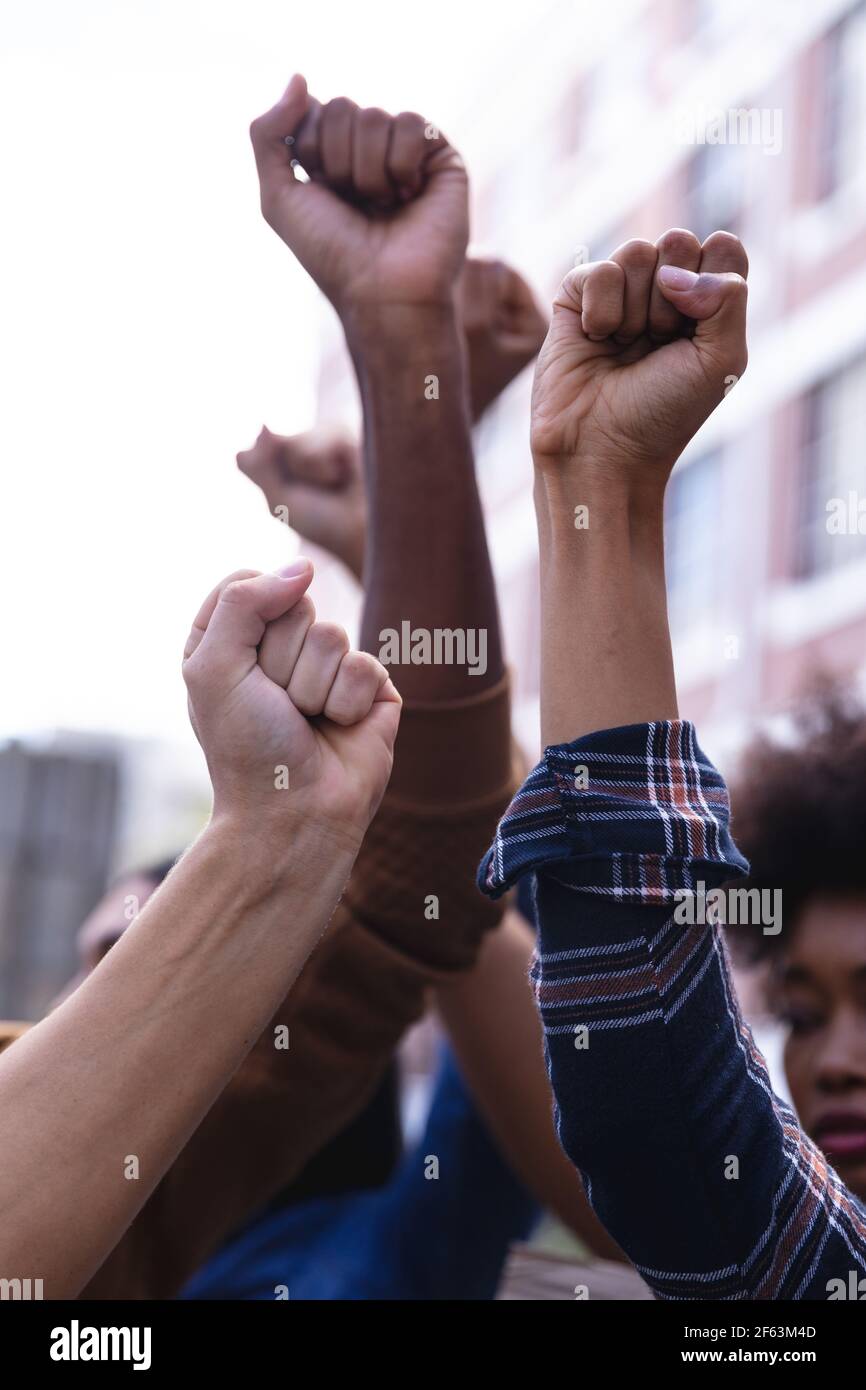 Raised fists of diverse male and female protesters demonstrating on ...