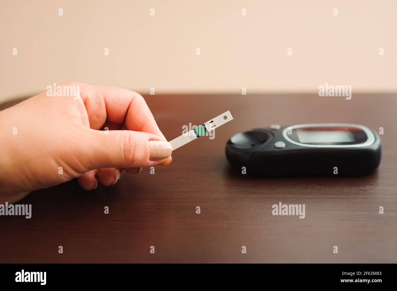 Diabetic patient doing glucose level blood test using ultra mini ...