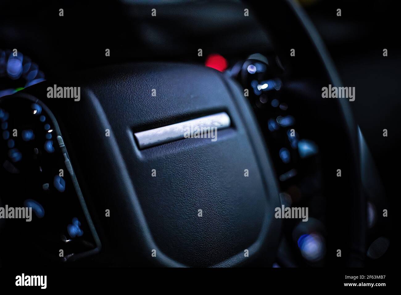 black leather multi-function steering wheel in the interior of a ...