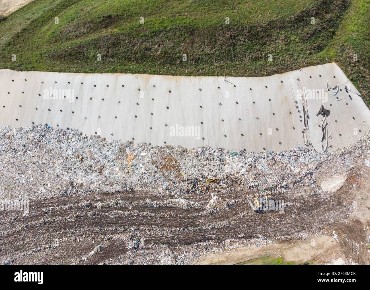 Garbage trucks unload garbage to a landfill Stock Photo - Alamy