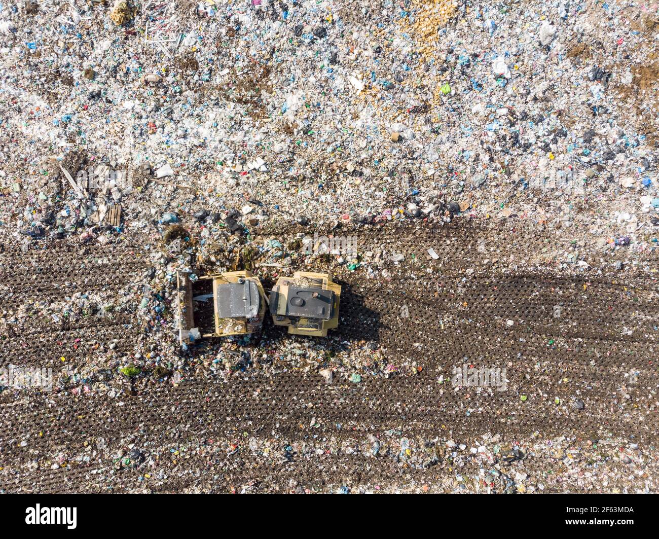 Garbage trucks unload garbage to a landfill Stock Photo - Alamy