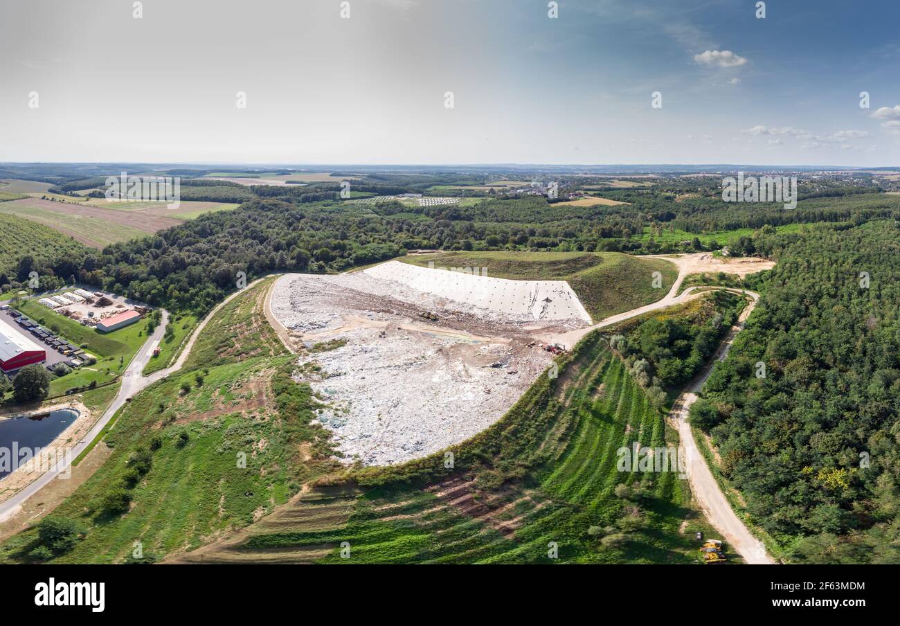 Garbage trucks unload garbage to a landfill Stock Photo - Alamy