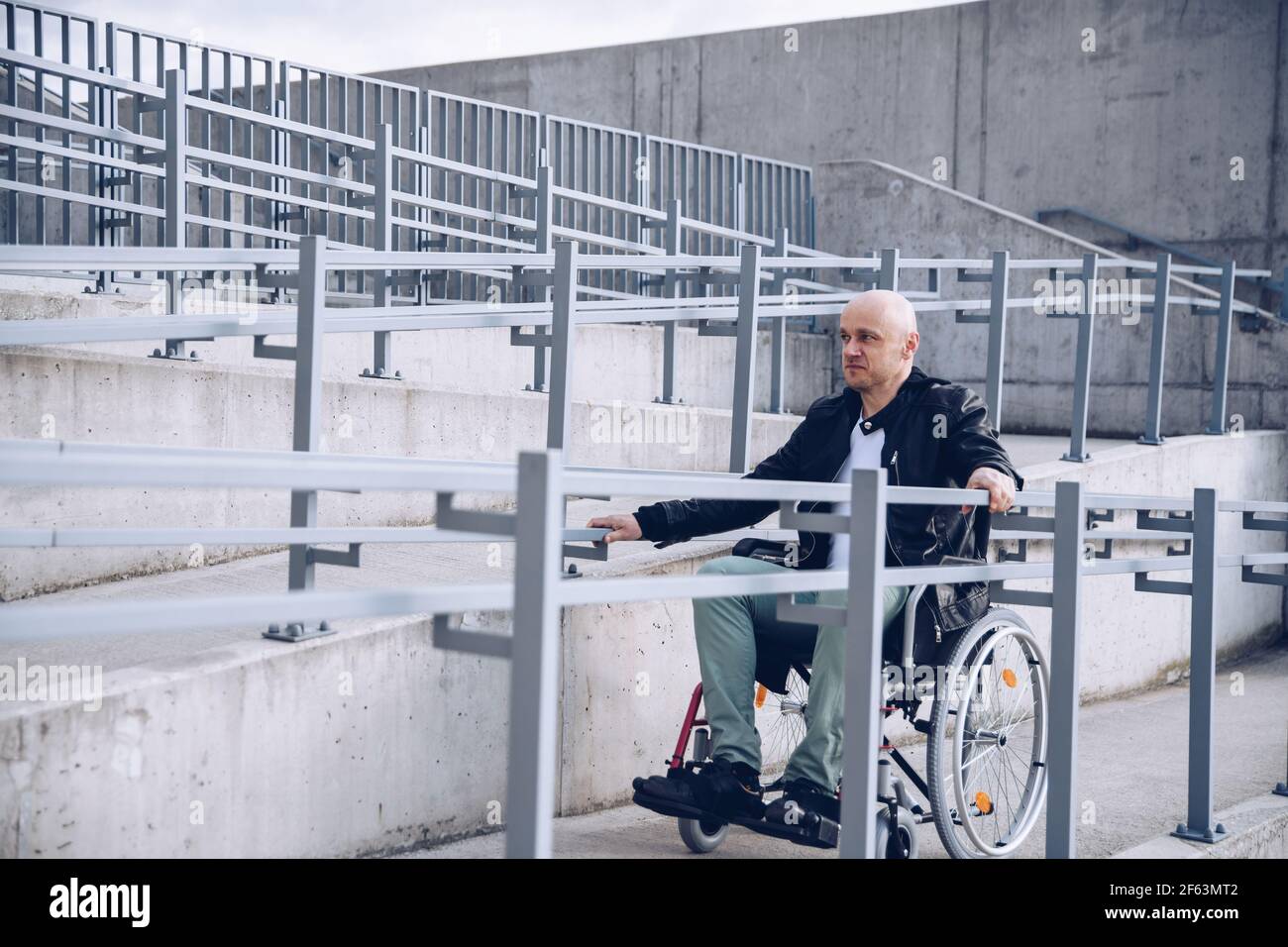 Disabled man in wheelchair on the beginning of the ramp Stock Photo - Alamy