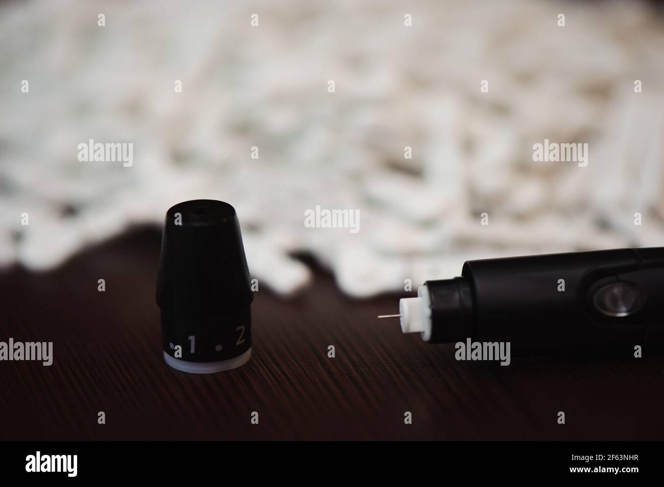 Diabetes pen injection needle. Lancets for an insulin pen on a wooden ...