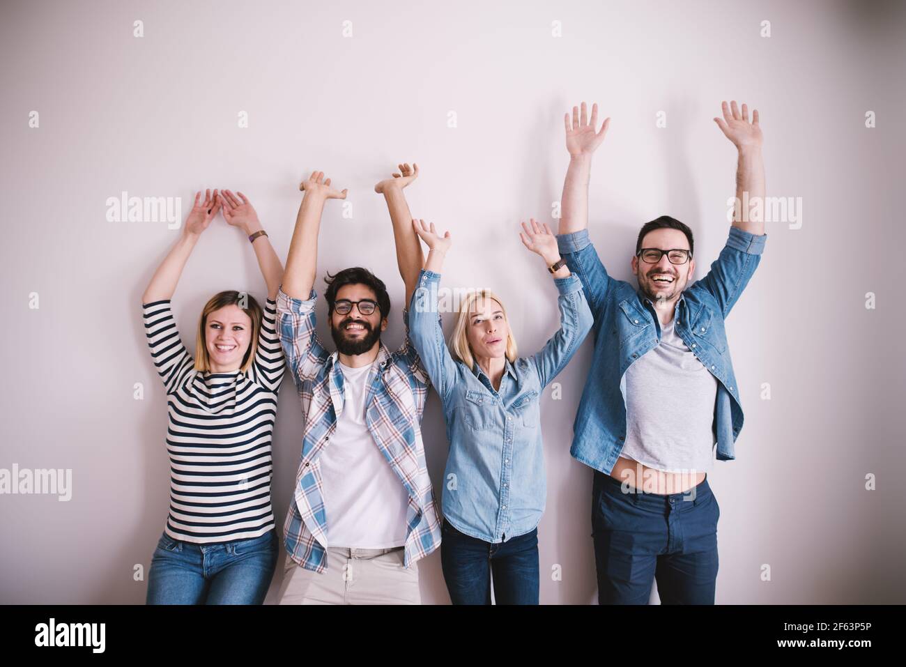 Group of young beautiful charming smiling people leaning against the ...