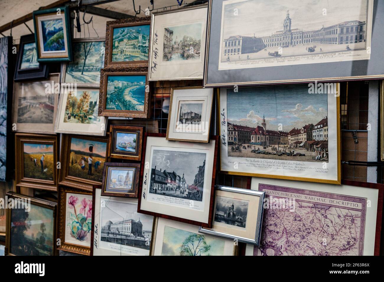 For Sale; old paintings, prints, maps and photographs in frames hanging ...