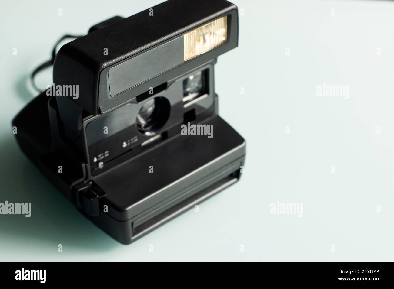 Retro old fashioned instant camera on a white glass background Stock ...