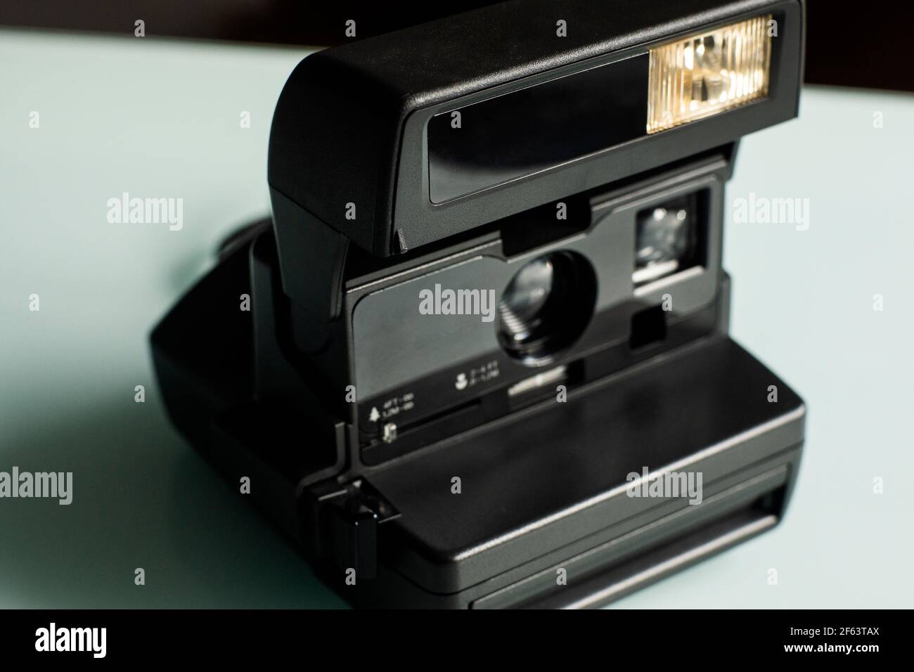 Retro old fashioned instant camera on a white glass background Stock ...