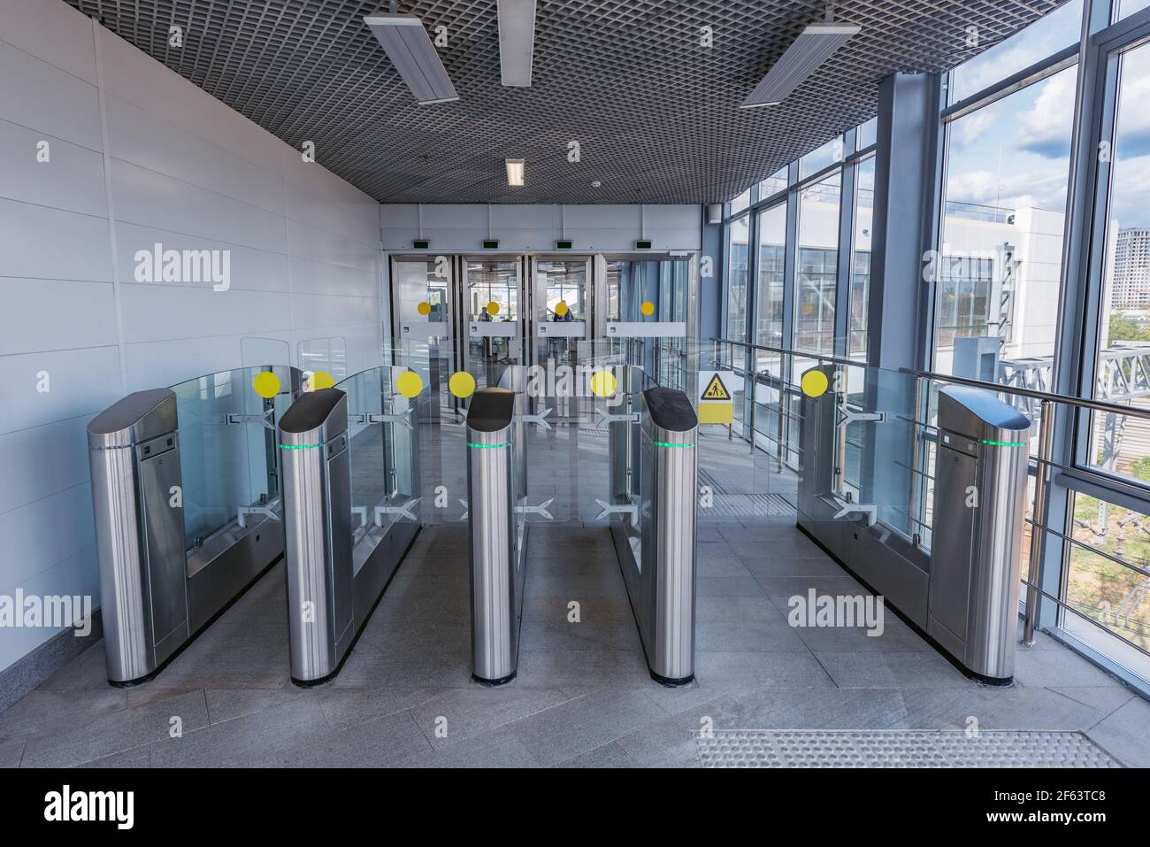 Turnstiles with electronic card readers on the station platform Stock ...