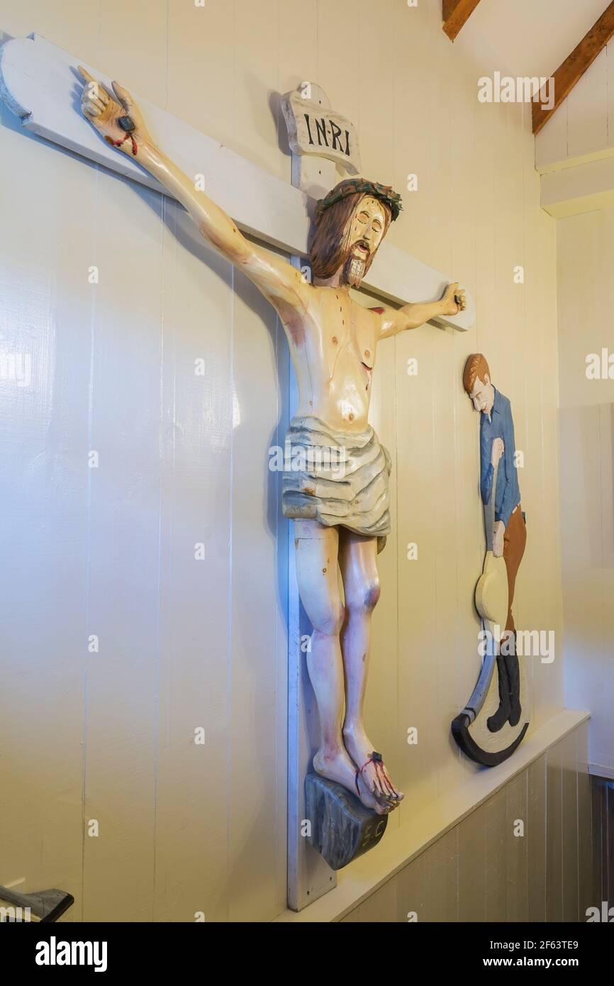 Jesus on the cross wooden sculpture on wall of staircase leading to ...