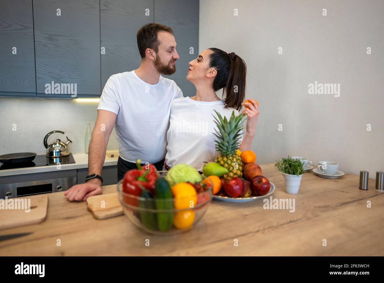 Couple Together In The Kitchen With Fruit And Vegetables Stock Photo ...