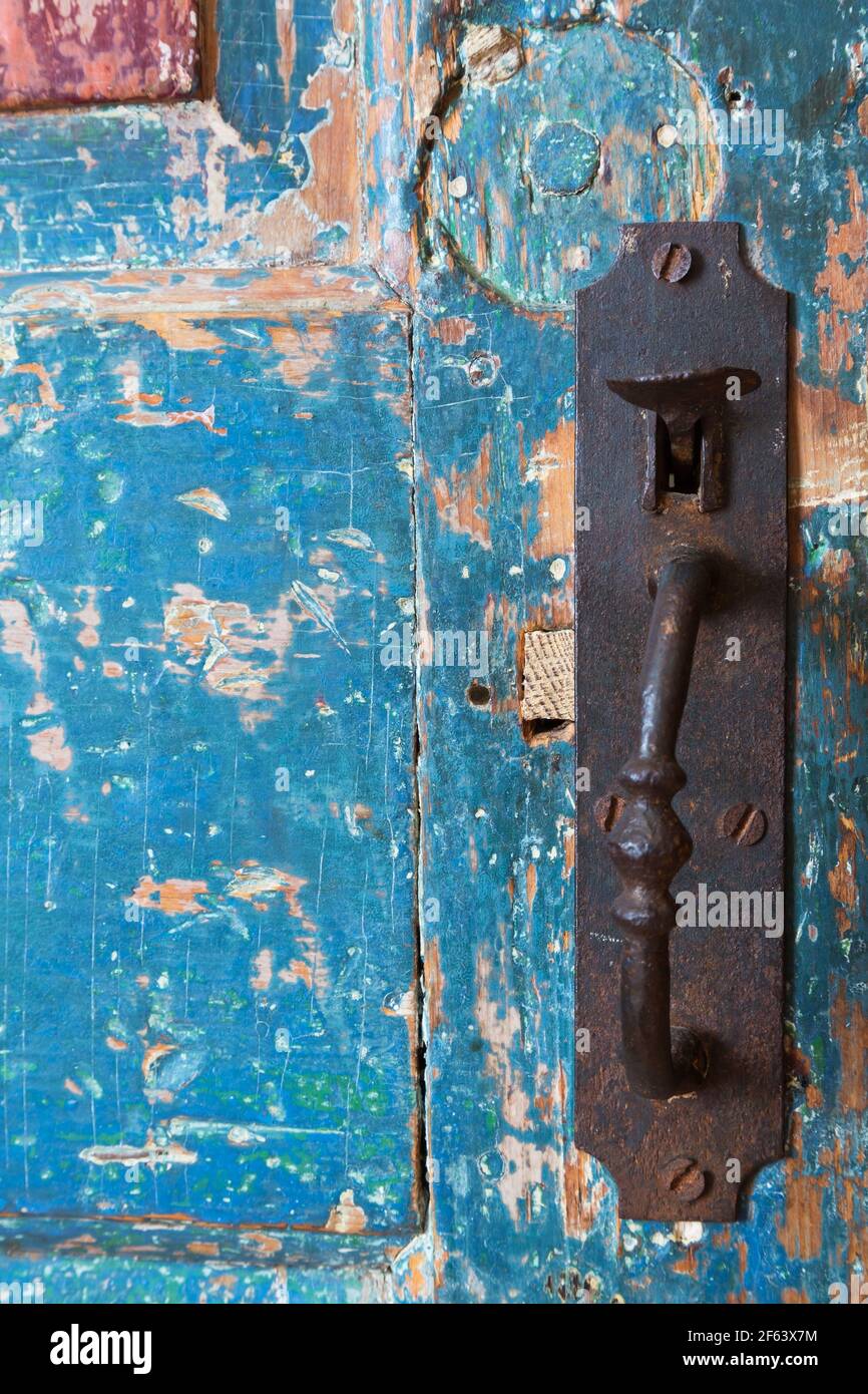 Close-up of rusted metal handle with backplate and thumblatch on ...