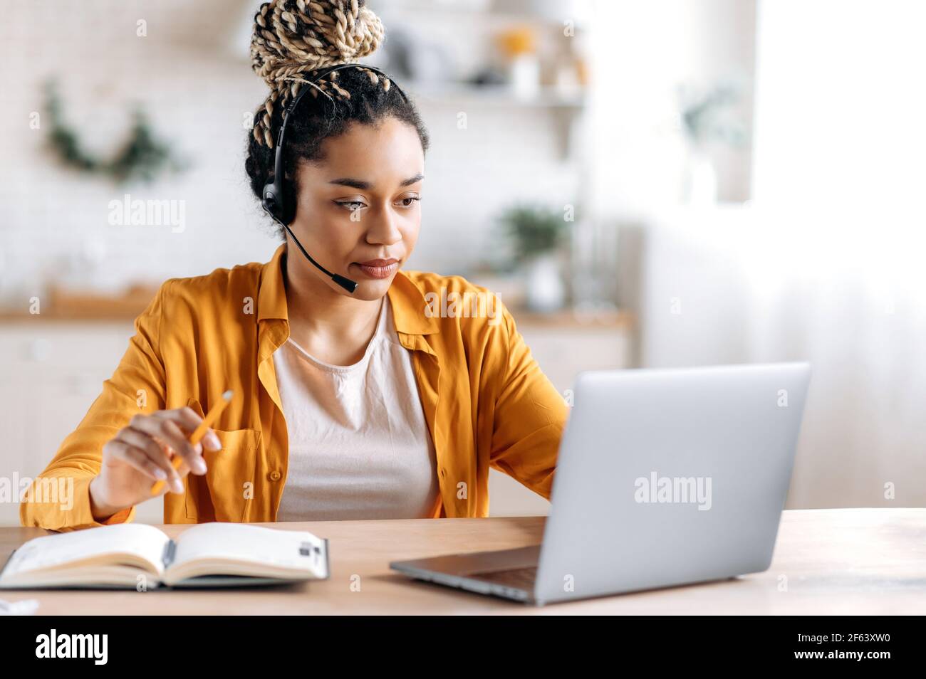 Focused smart beautiful young African American woman with dreadlocks ...