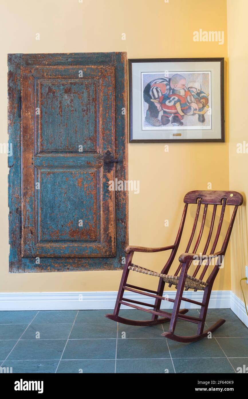 Antique wooden rocking chair with weaved seat and old distressed door ...