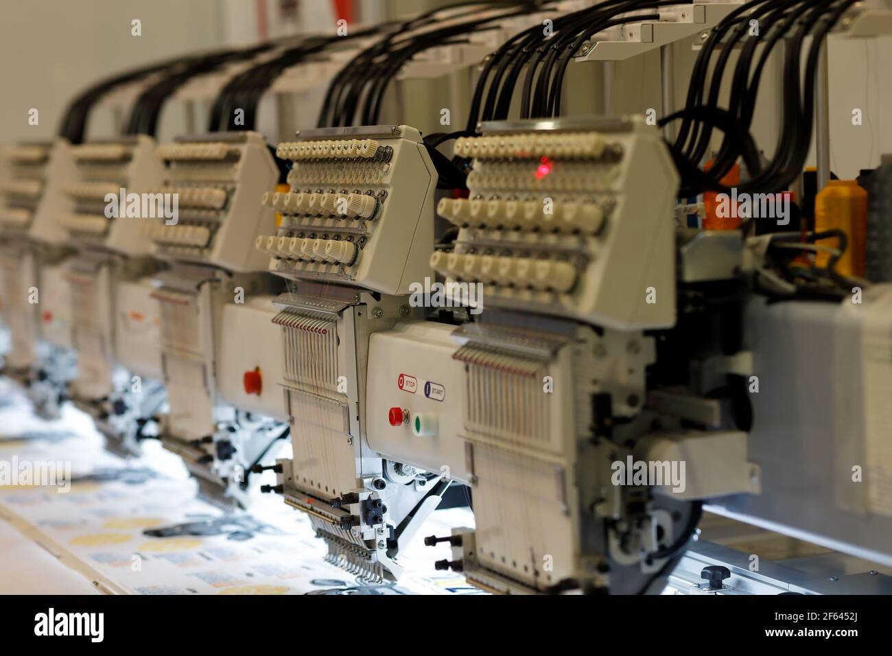 Modern multi head embroidery machine close up. Selective focus Stock ...