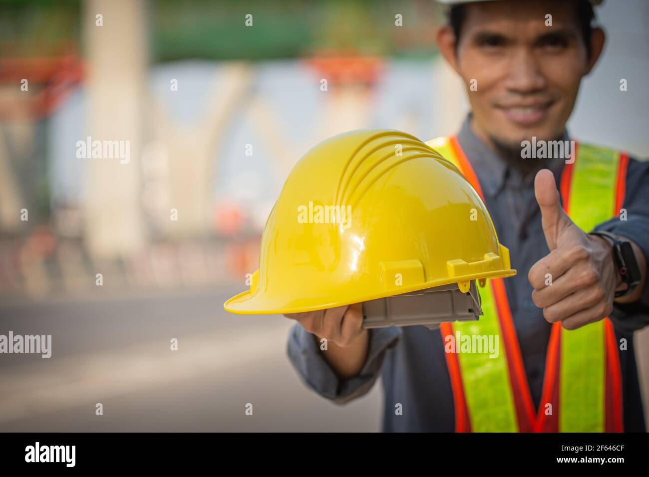 Engineer holding helmet on site Road construction For the development ...